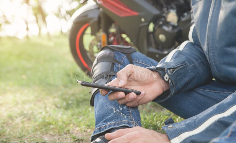 Biker Using Smartphone in Nature Stock Image - Image of resting, adult ...