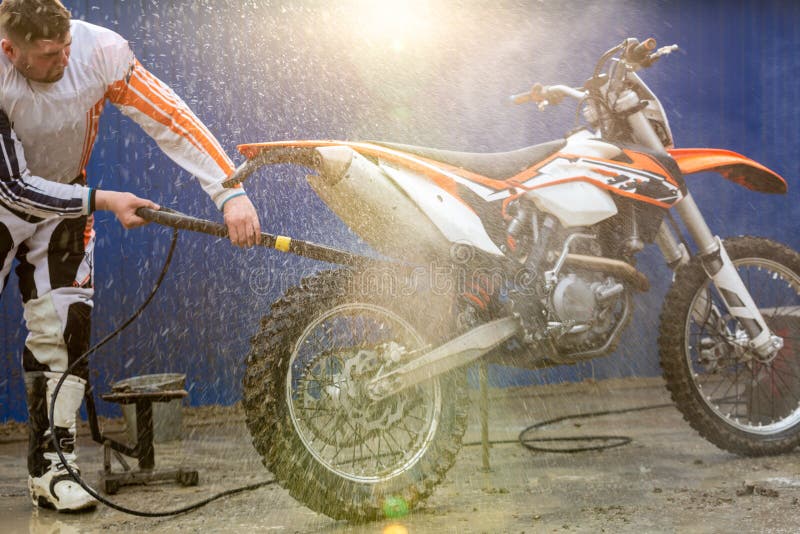 Biker washes a motorcycle stock photo. Image of design - 117347158