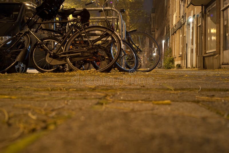 Bikes on the sidewalk stock photo. Image of street, evening - 21993434