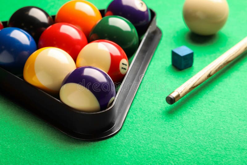 Billiard Balls in Triangle Rack, Cue and Chalk on Green Table, Closeup ... Billiard Balls in Triangle Rack, Cue and Chalk on Green Table, Closeup ...