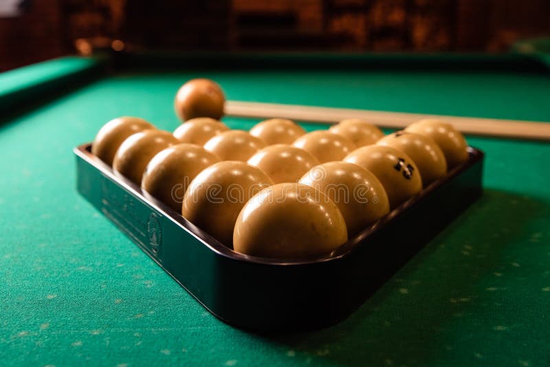 Billiard Cues and Pyramid of Yellow Pool Balls on Green Billiard Table ...