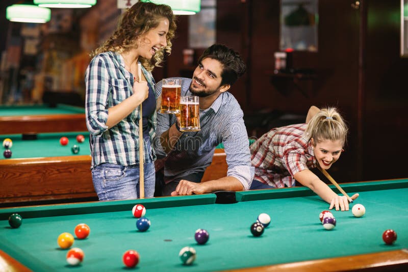 Billiard Game. Group of Friends Playing Pool Together Stock Photo ...