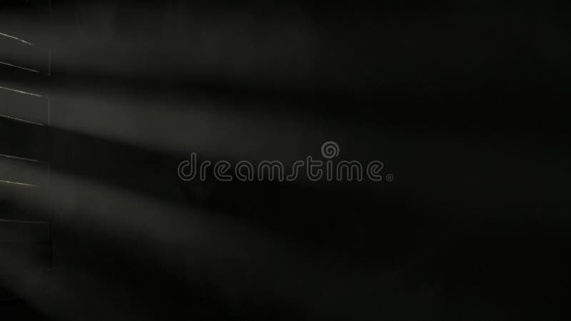 A Billowing Smoke or Fog on a Black Background, Illuminated by Rays of ...