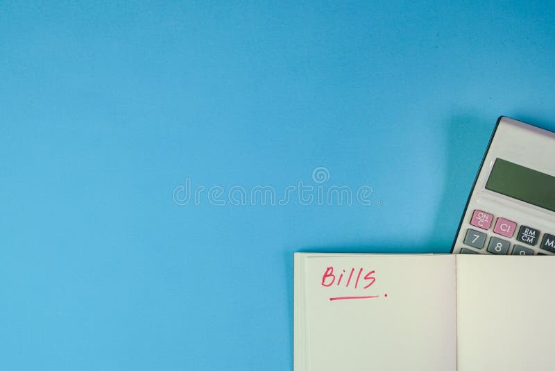 Bills. Notepad with Calculator on Top of Blue Color Table Stock Image ...