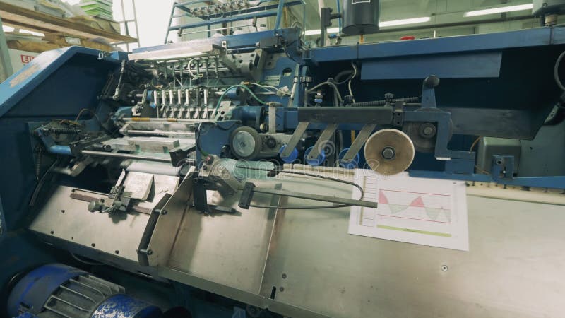 Binding Machine and Paper Pages with Diagrams Moving through it Stock ...