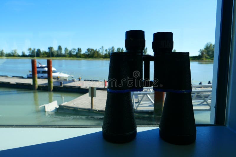 Binoculars on a Window Sill Overlooking a Dock Stock Photo - Image of ...