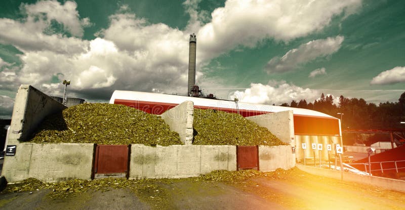 Bio Power Plant With Storage Of Wooden Fuel Against Blue Sky Stock