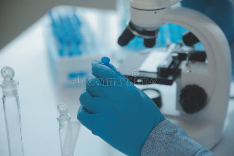 Biochemical Research Scientist Team Working with Microscope for ...