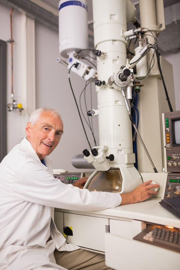 Biochemist Using Large Microscope and Computer Stock Photo - Image of ...