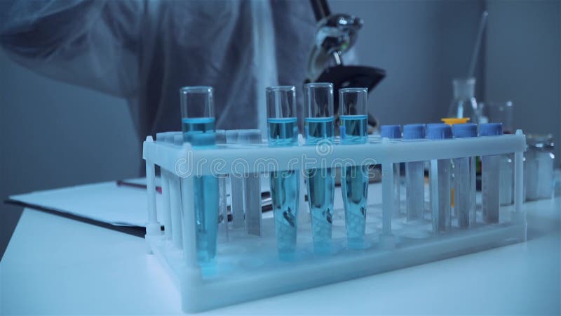 Biochemistry Laboratory Research, Chemist in Protective Suit Analyzing ...