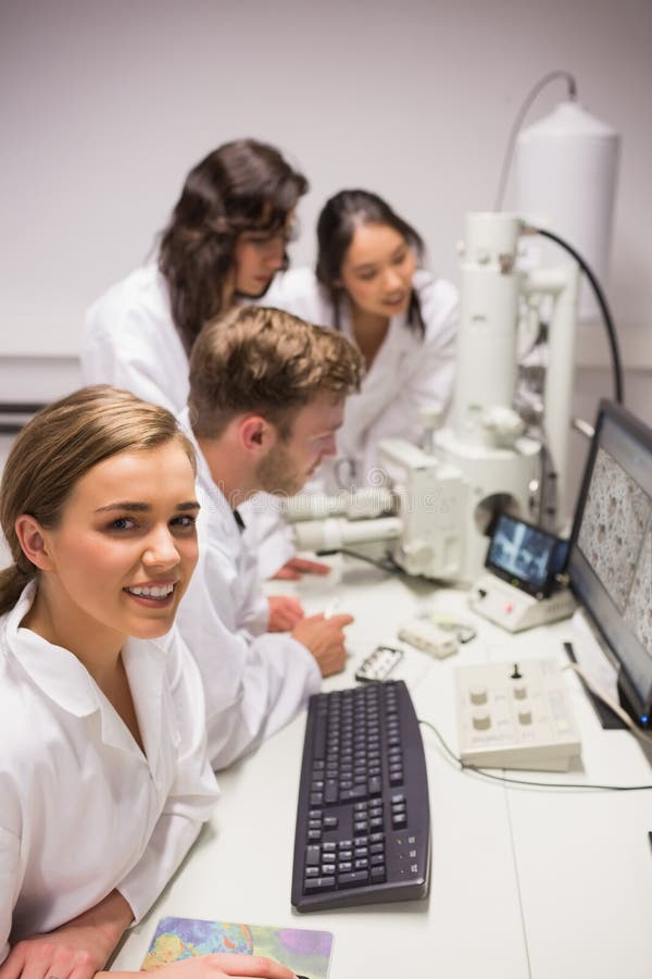 Biochemistry Students Using Large Microscope and Computer Stock Image ...
