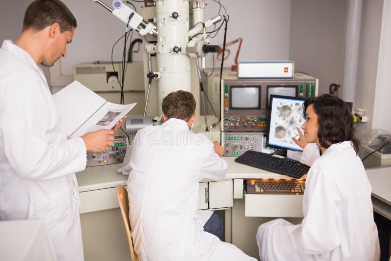 Biochemistry Students Using Large Microscope and Computer Stock Image ...