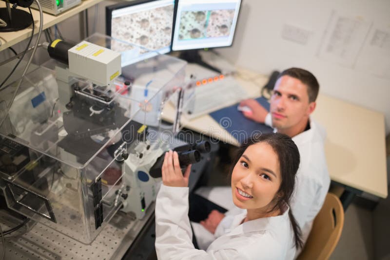 Biochemistry Students Using Large Microscope and Computer Stock Photo ...