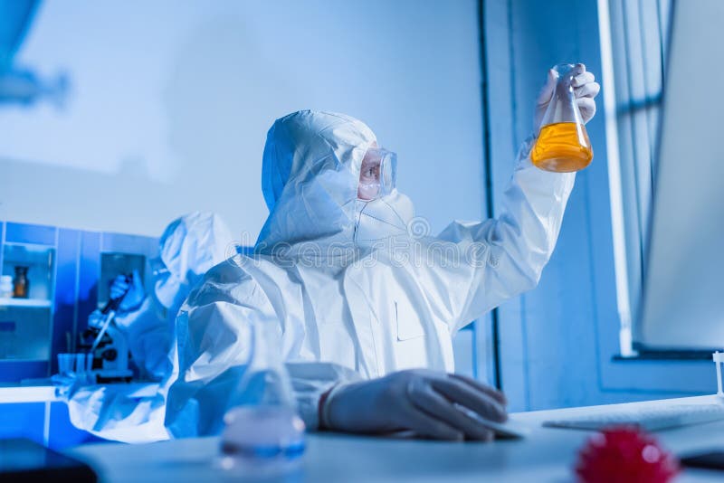 Bioengineer in Hazmat Suit Looking at Stock Image - Image of orange ...