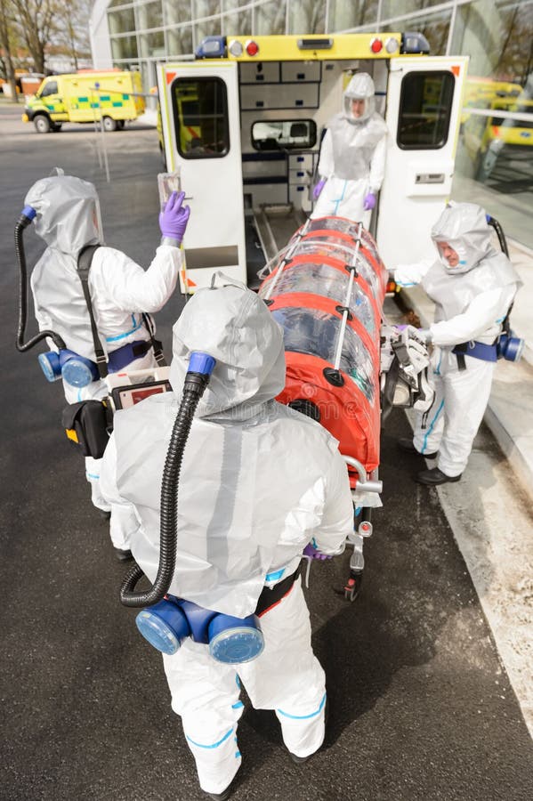 Biohazard Team Loading Stretcher in Ambulance Stock Photo - Image of ...