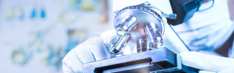 Biological Scientist Looking at Samples by Using Microscope Doing ...