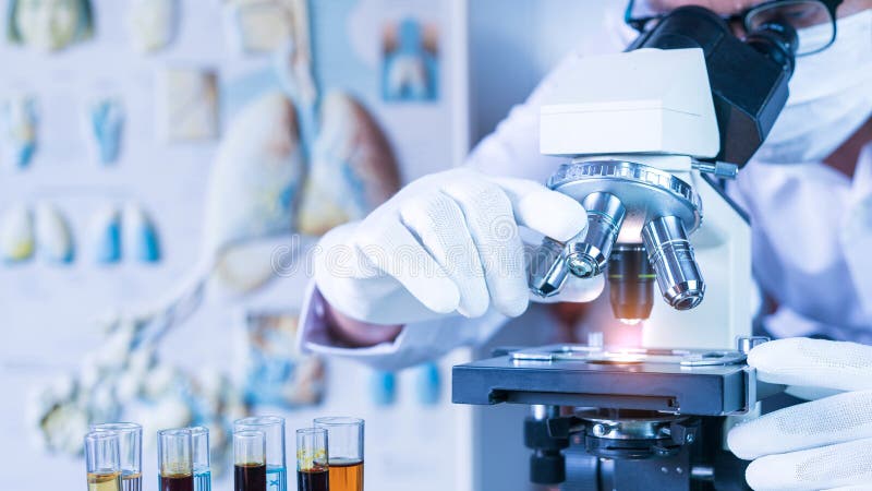 Biological Scientist Looking at Samples by Using Microscope Doing ...