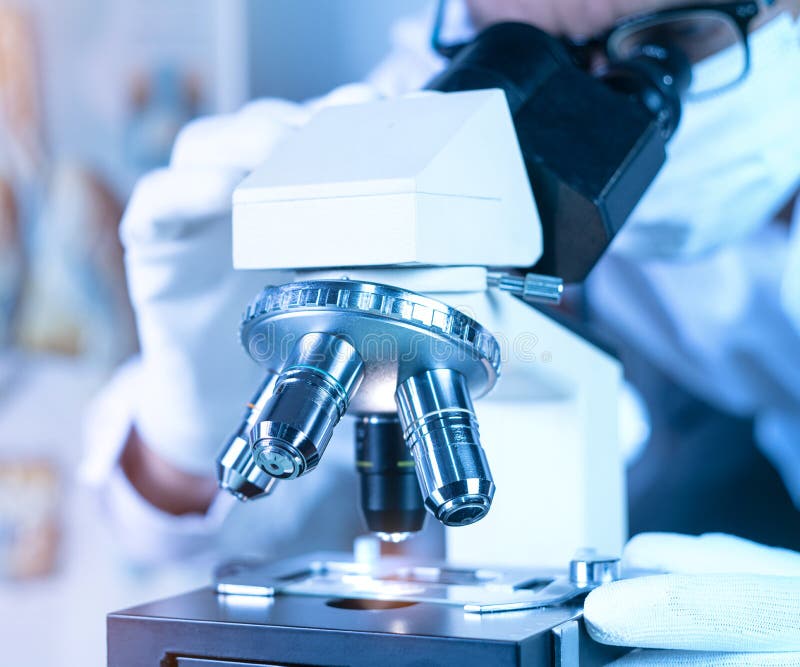Biological Scientist Looking at Samples by Using Microscope Doing ...