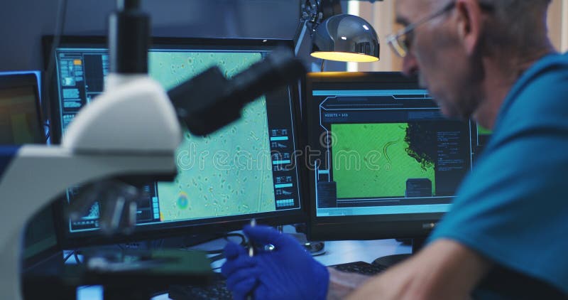 Biologist Analyzing Sample with Microscope Stock Image - Image of ...