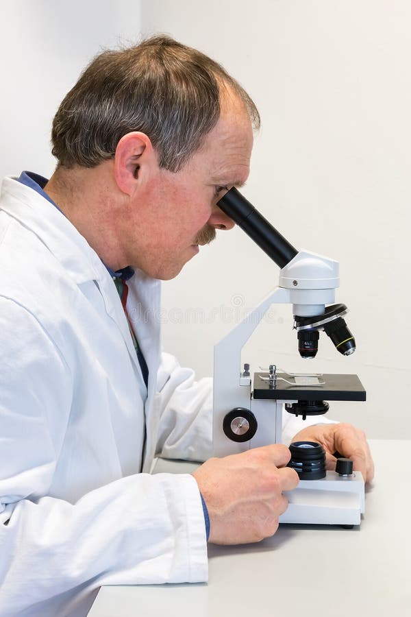 Biologist in Lab Coat Looking through Microscope Stock Photo - Image of ...