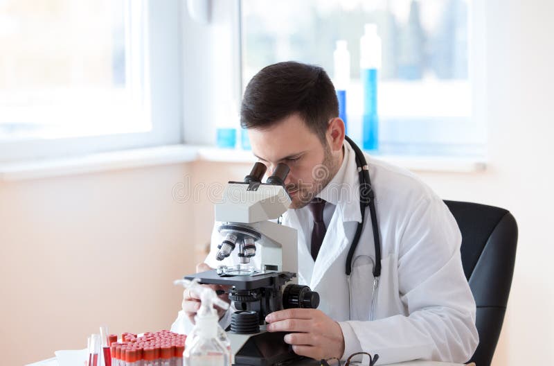 Biologist with Microscope in Laboratory Stock Image - Image of coat ...