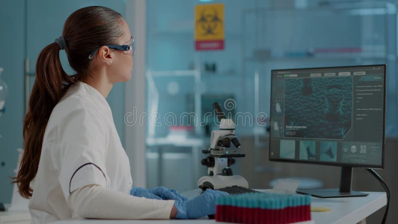 Biology Researcher Using Computer and Taking Notes Stock Video - Video ...