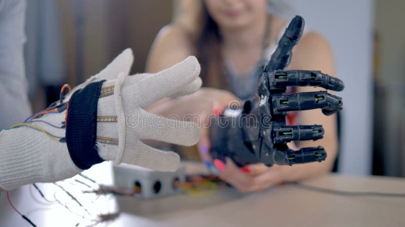 Girl`s Hand Moving, Bionic Arm Repeating Its Moves. 4K. Stock Video ...