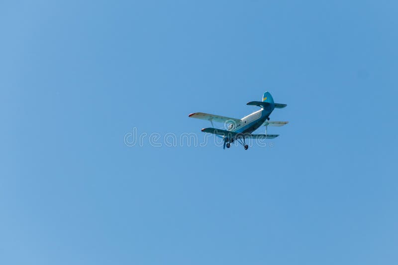 Biplane flying in blue sky stock photo. Image of airport - 131358080