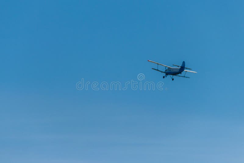 Biplane flying in blue sky stock image. Image of single - 154722947