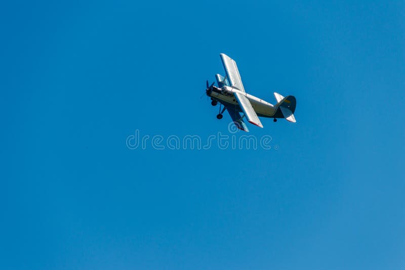 Biplane flying in blue sky stock photo. Image of airplane - 154722966
