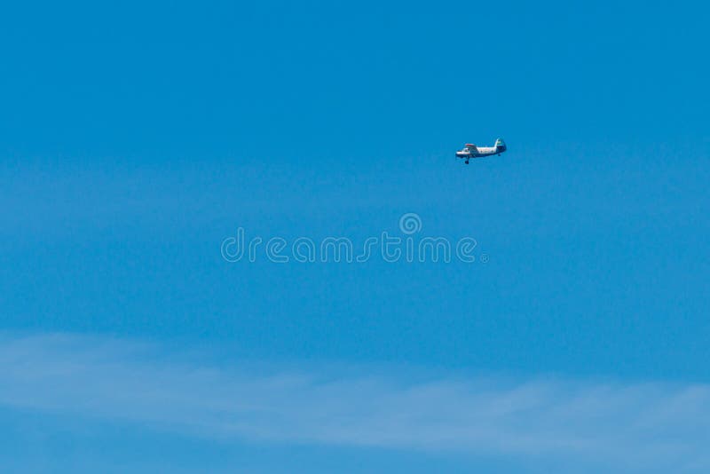 Biplane flying in blue sky stock image. Image of airfield - 184538289