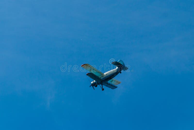 Biplane flying in blue sky stock photo. Image of outdoor - 184538304