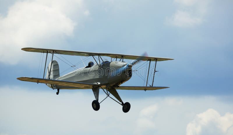 Biplane flying in sky stock image. Image of demonstrations - 263941421