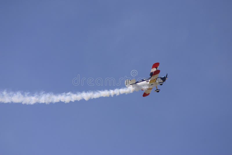 Biplane with Trailing Smoke Stock Image - Image of show, plane: 250787