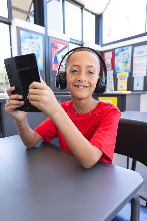 Biracial Boy Enjoys Technology at School Using a Tablet Stock Photo ...