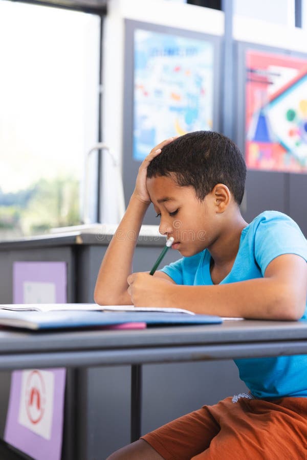 Biracial Boy Focused on Schoolwork at School Stock Photo - Image of ...