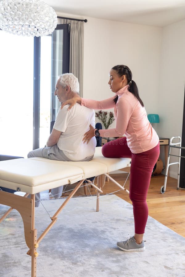 Biracial Female Physiotherapist Giving Back Massage Therapy To