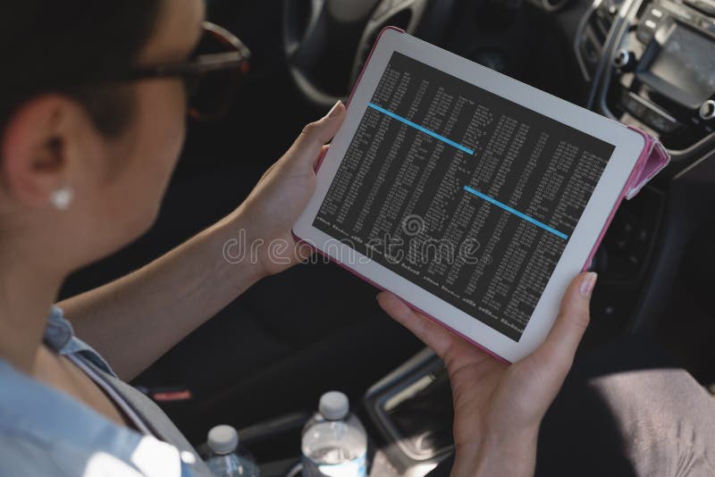 Biracial Female Programmer Sitting in Car, Using Tablet with Coding on ...