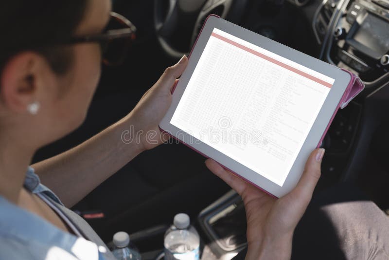 Biracial Female Programmer Sitting in Car and Using Tablet with Coding on Screen Stock Photo ...
