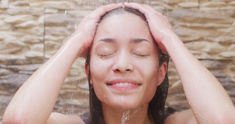 Biracial Woman Smiling And Taking Shower In Bathroom Stock Footage