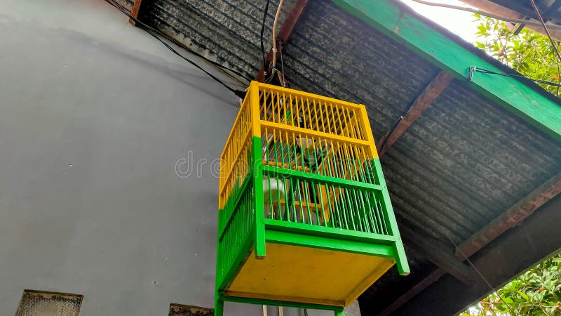 A Bird Cage is Hung in Front of the Terrace of a Resident& X27;s House ...