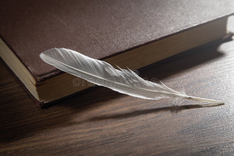 Bird Feather and Book on the Wooden Table Stock Photo - Image of quill ...