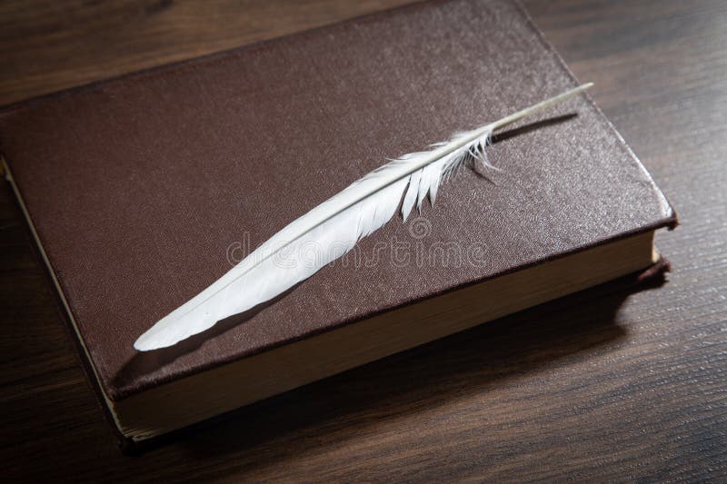 Bird Feather and Book on the Wooden Table Stock Photo - Image of ...
