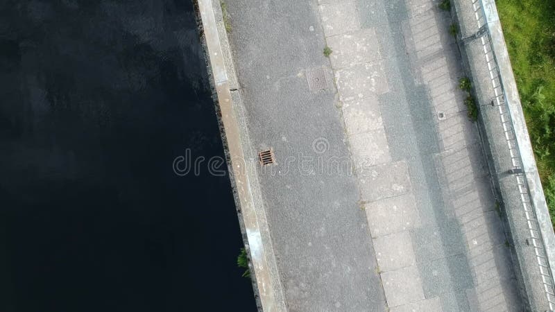 Bird S Eye View of a Construction on a Water Dam Surrounded by Greenery ...