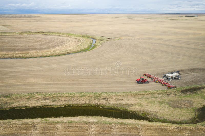 Bird S-eye View of a Farming Field and Seeding Machine during Daytime ...