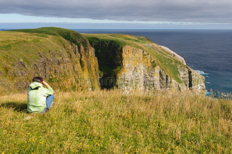 Birdwatcher Looking at Birds on Coastal Cliffs Stock Photo - Image of ...