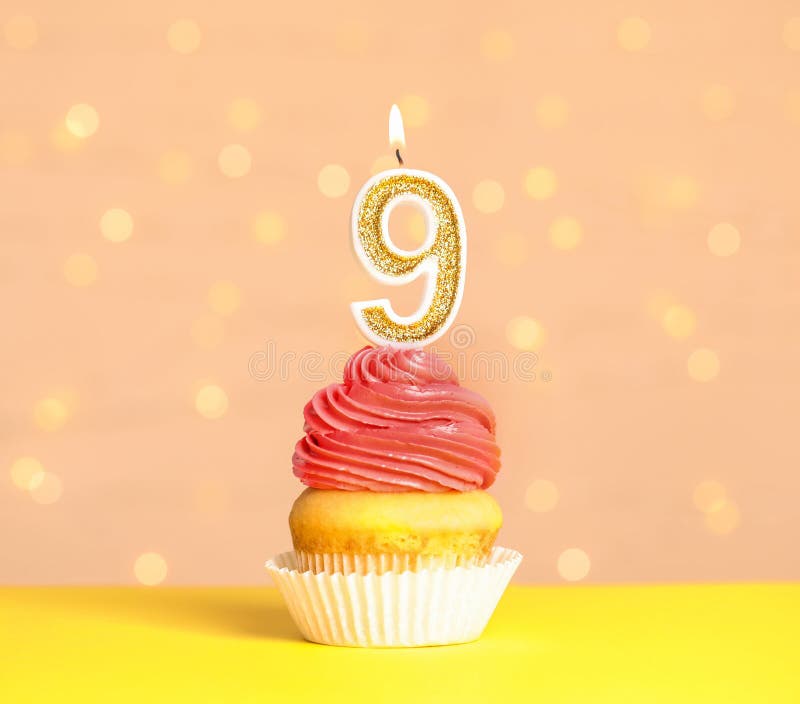 Birthday Cupcake with Number Nine Candle on Table Festive Lights Stock ...