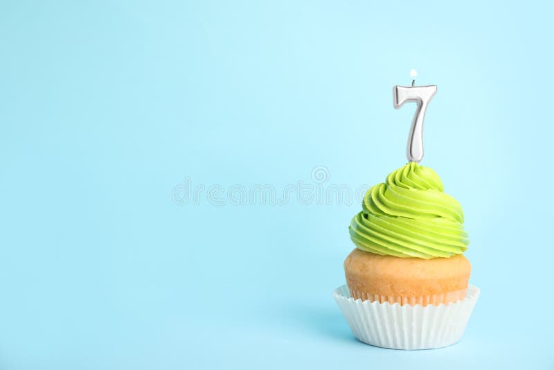 Birthday Cupcake with Number Seven Candle on Blue Background Stock ...