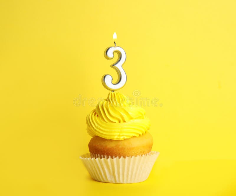 Birthday Cupcake with Number Two Candle in Saucer on Orange Background ...