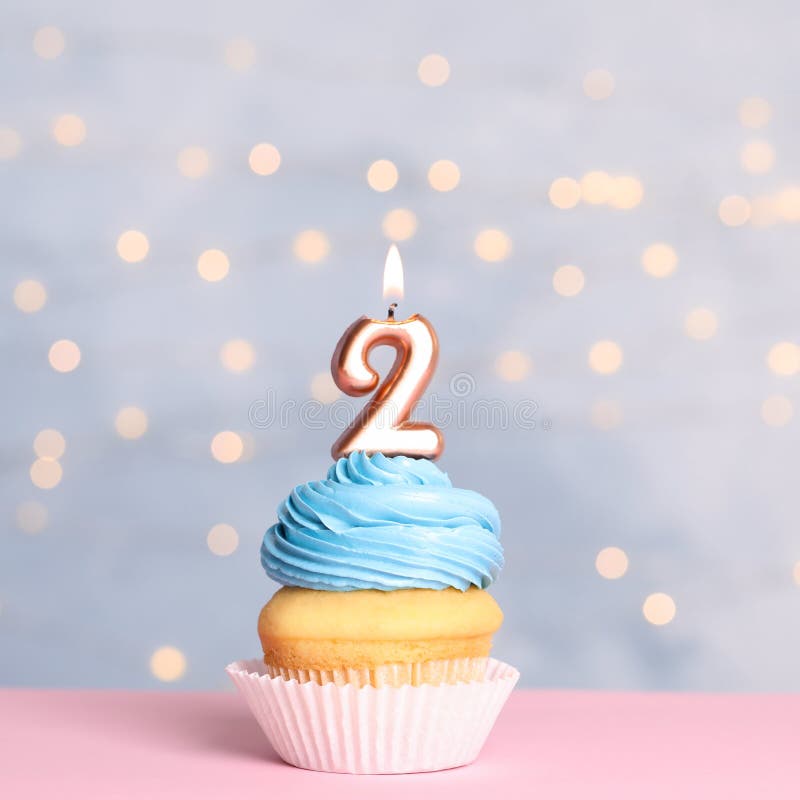 Birthday Cupcake with Number Two Candle on Table Stock Image - Image of ...